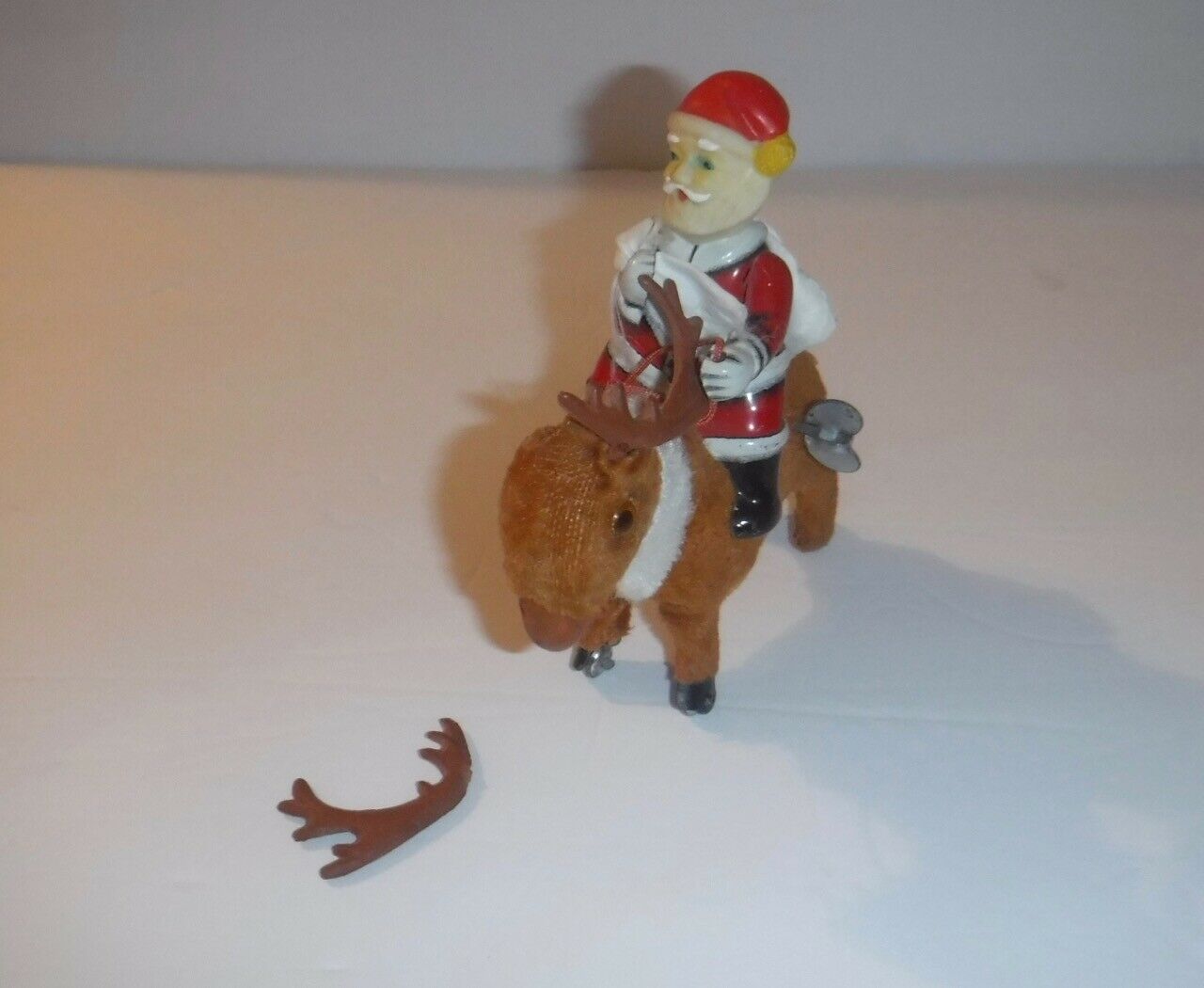 Vintage Wind Up Tin Litho Santa Riding Reindeer Christmas Toy | #14611463