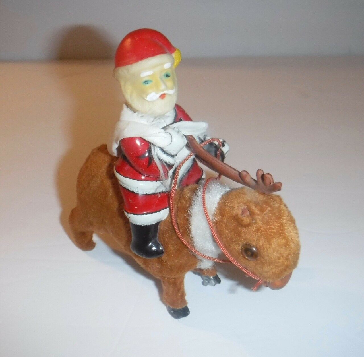 Vintage Wind Up Tin Litho Santa Riding Reindeer Christmas Toy | #14611463